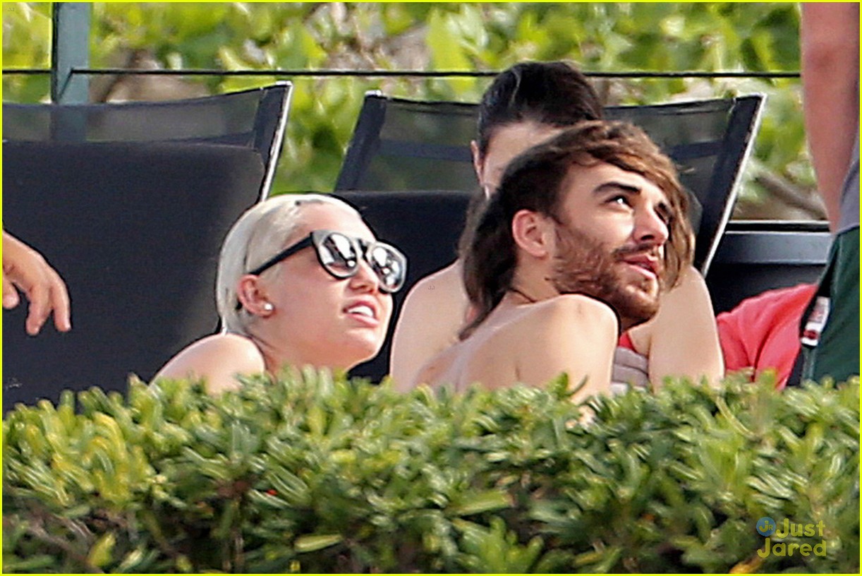 Full Sized Photo of miley cyrus wears a bikini douses herself with ...